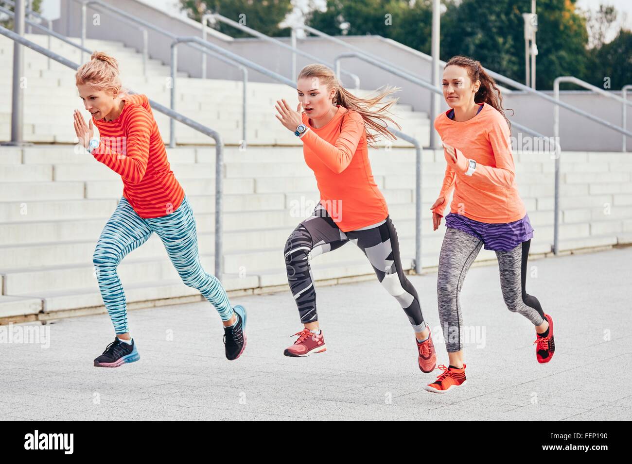 Three female runners racing at city stairway Stock Photo - Alamy