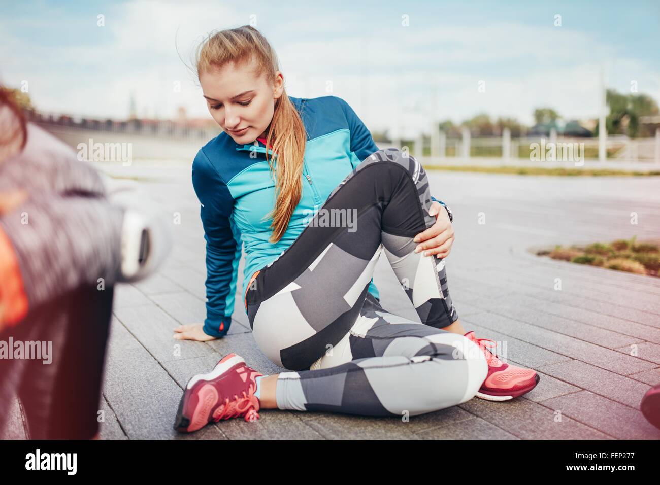 Woman doing stretches on running hi-res stock photography and images ...