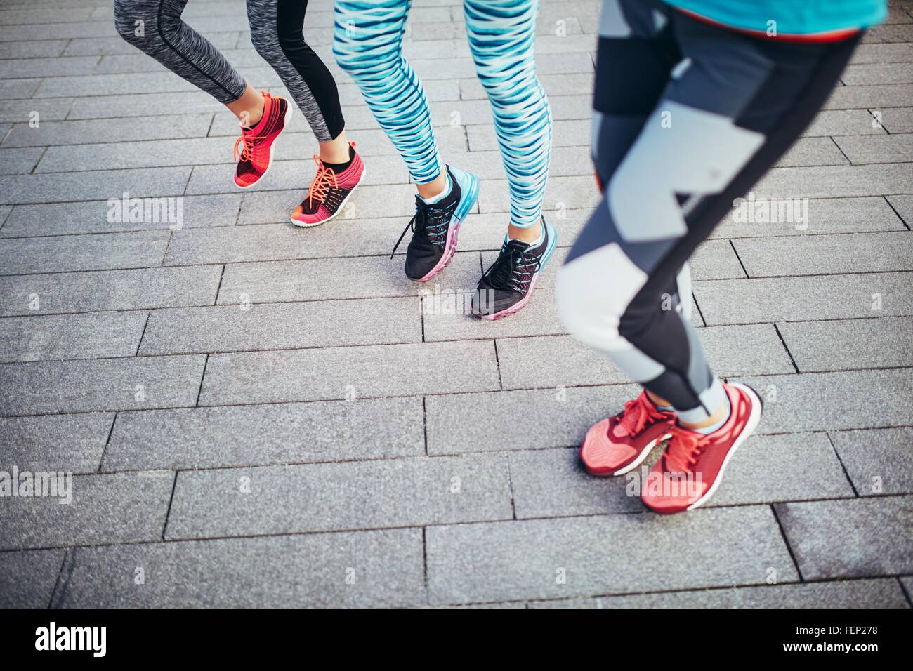 Legs of three female runners running on spot Stock Photo - Alamy