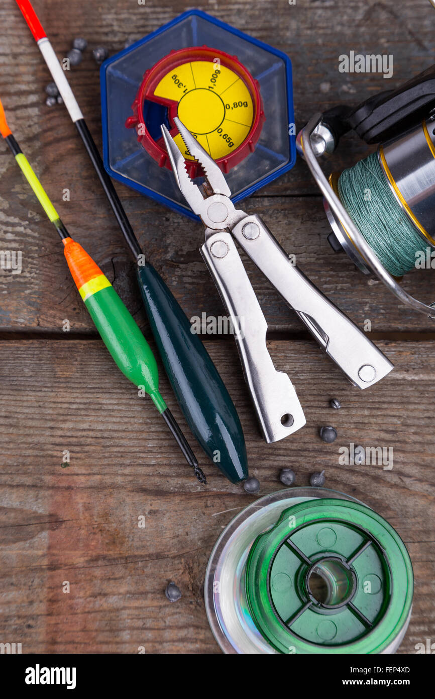fishing tackles for anglers - swimmers, plummets and tools on wooden ...