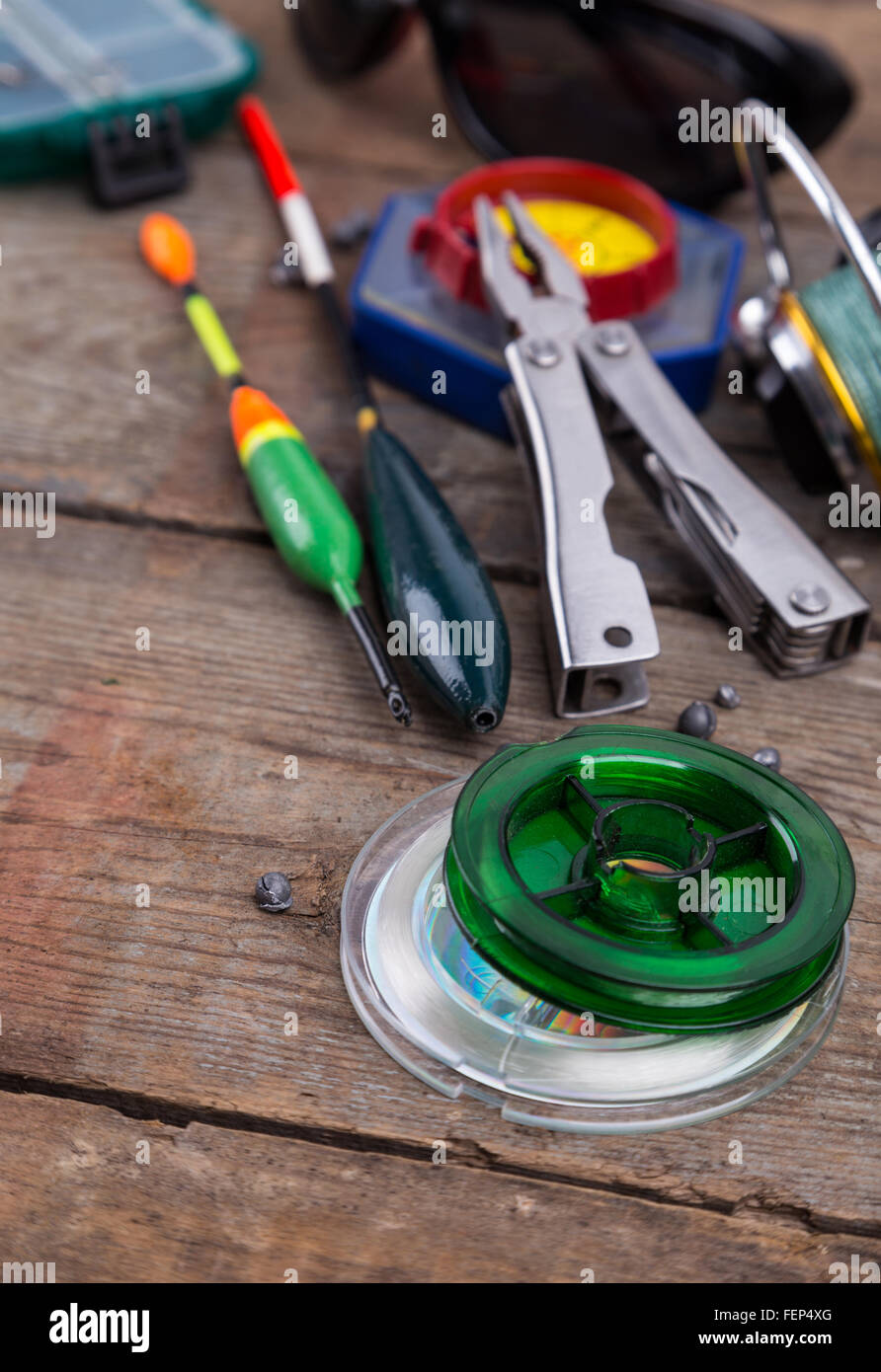 fishing tackles for anglers - swimmers, plummets and tools on wooden ...