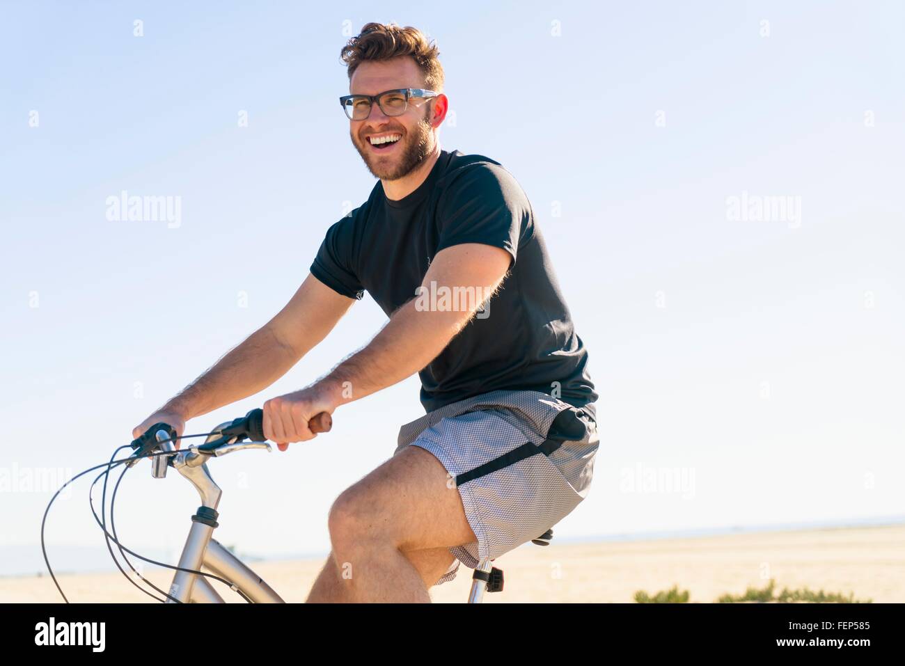 Young man, cycling, smiling Stock Photo - Alamy