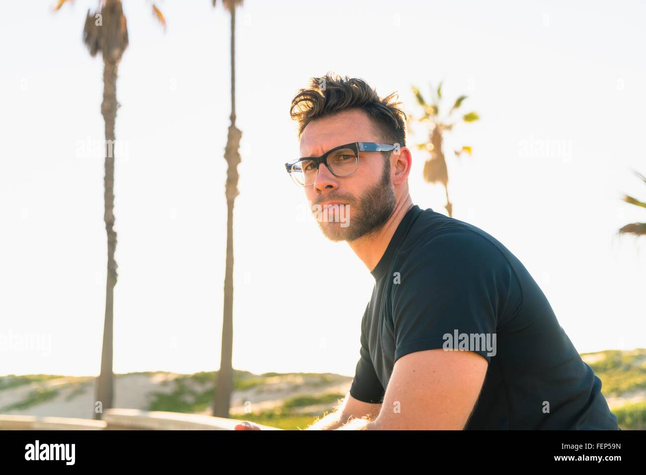 Portrait of young man, stern expression, outdoors Stock Photo - Alamy