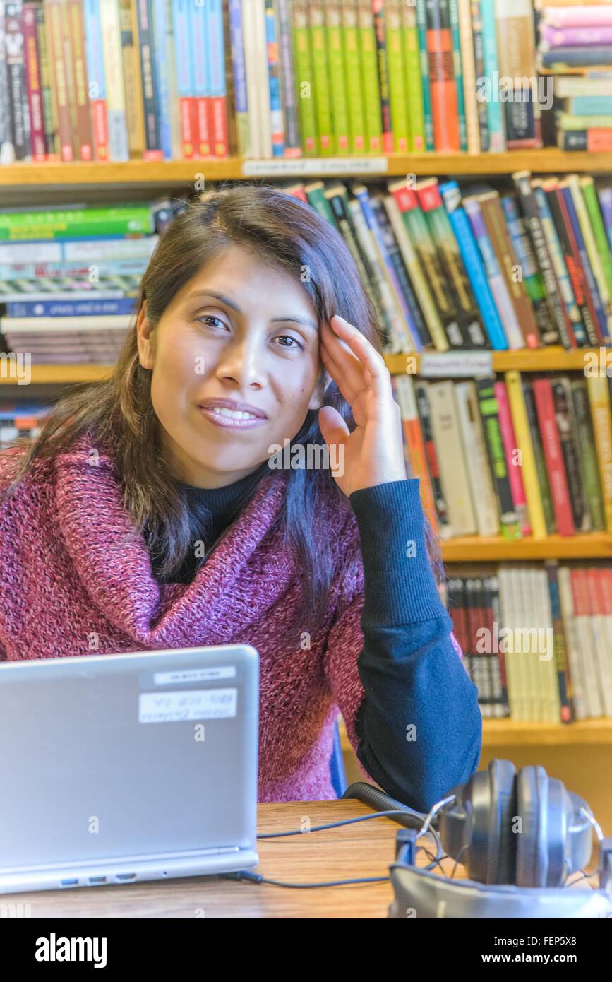 Portrait of mature female student using laptop in library Stock Photo ...