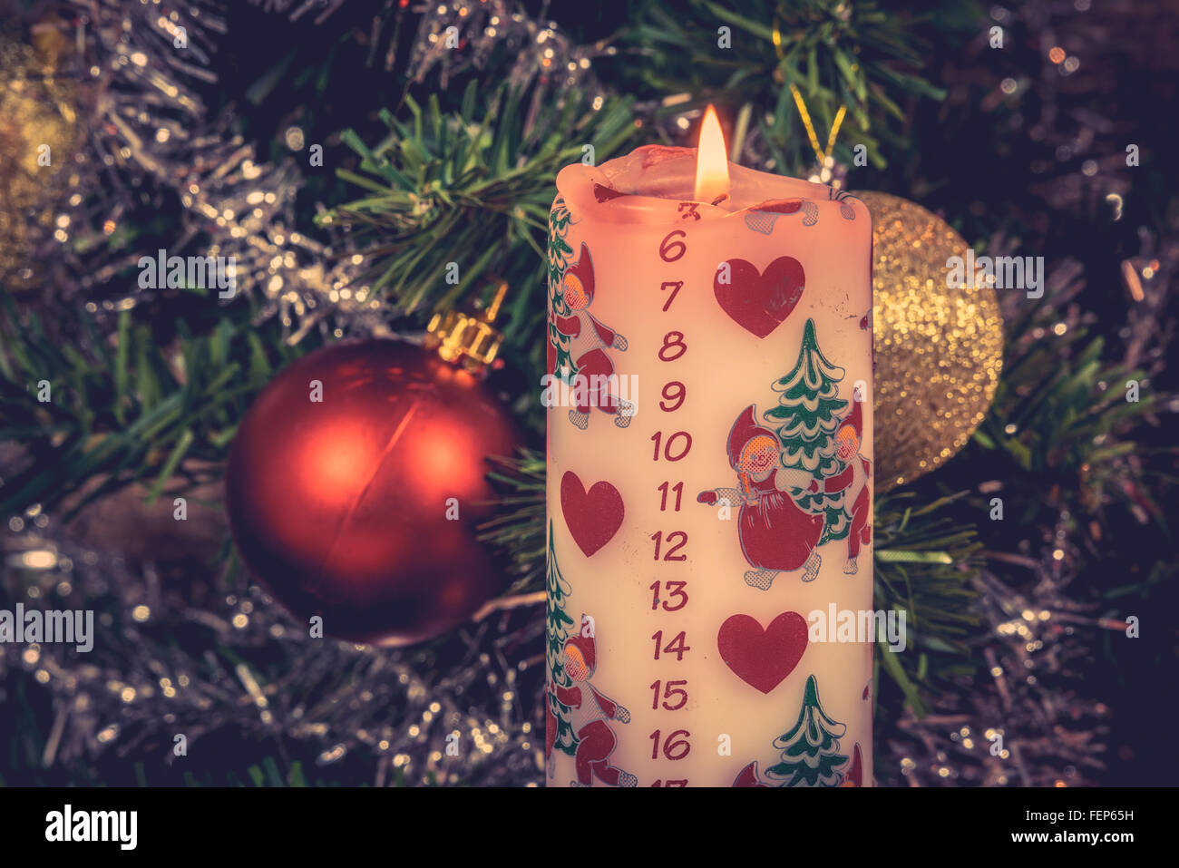 White Christmas candle with a december calendar Stock Photo - Alamy