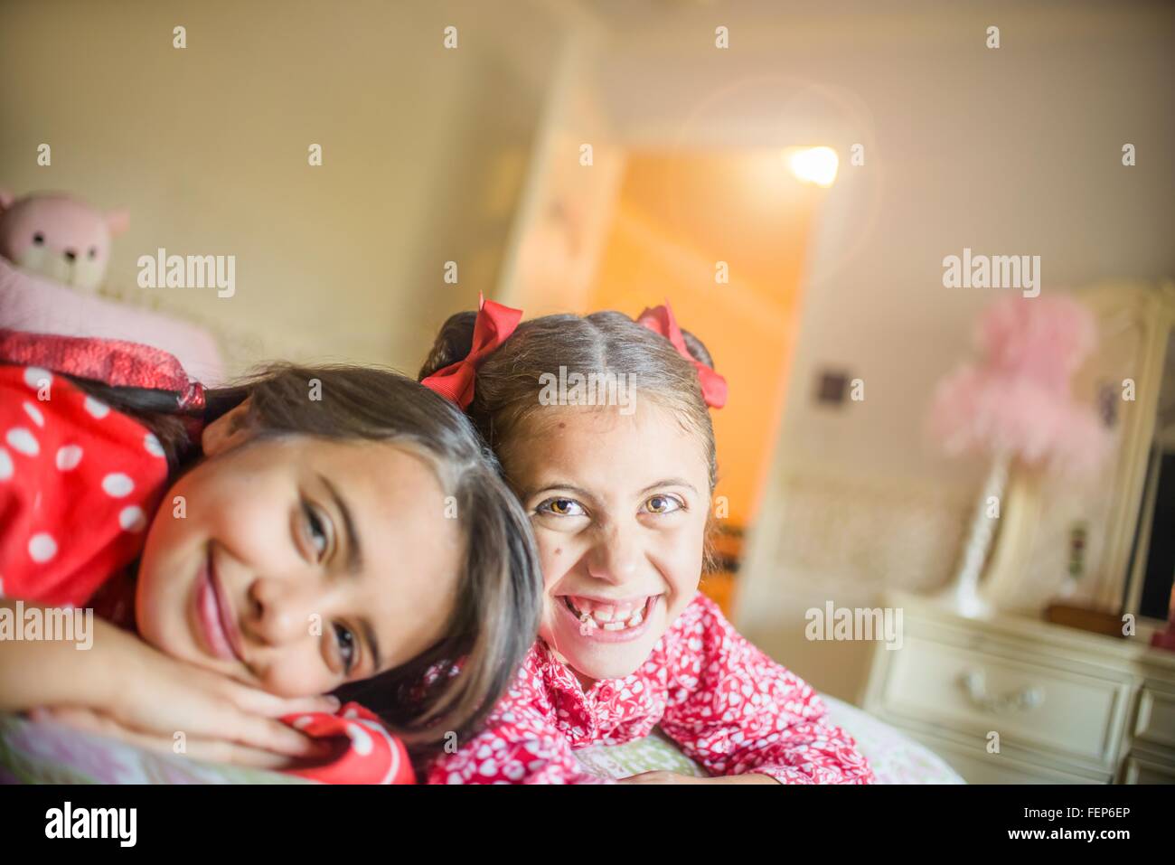 Portrait of two happy sisters lying on bed Stock Photo - Alamy Portrait of two happy sisters lying on bed Stock Photo - Alamy