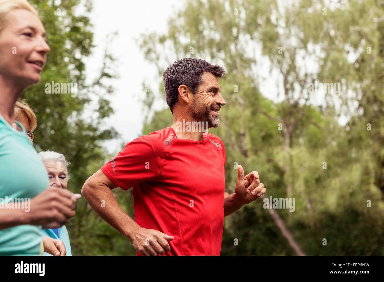 Group of adults running outdoors Stock Photo - Alamy