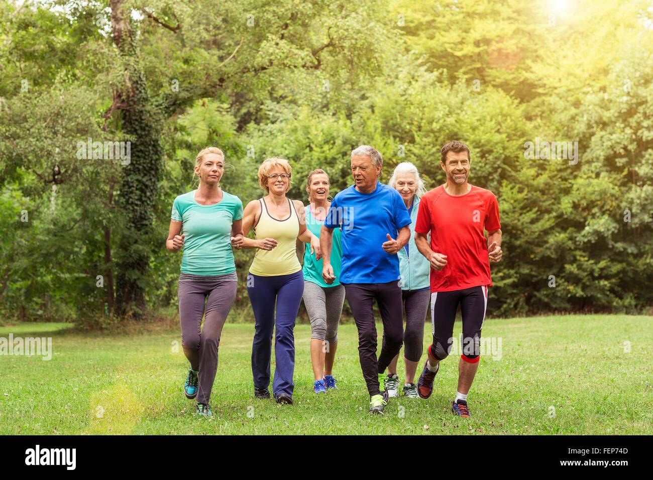 Group of adults running outdoors Stock Photo - Alamy