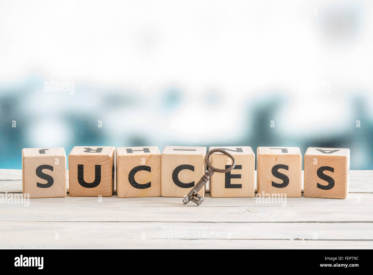 Key to success on a wooden table Stock Photo - Alamy