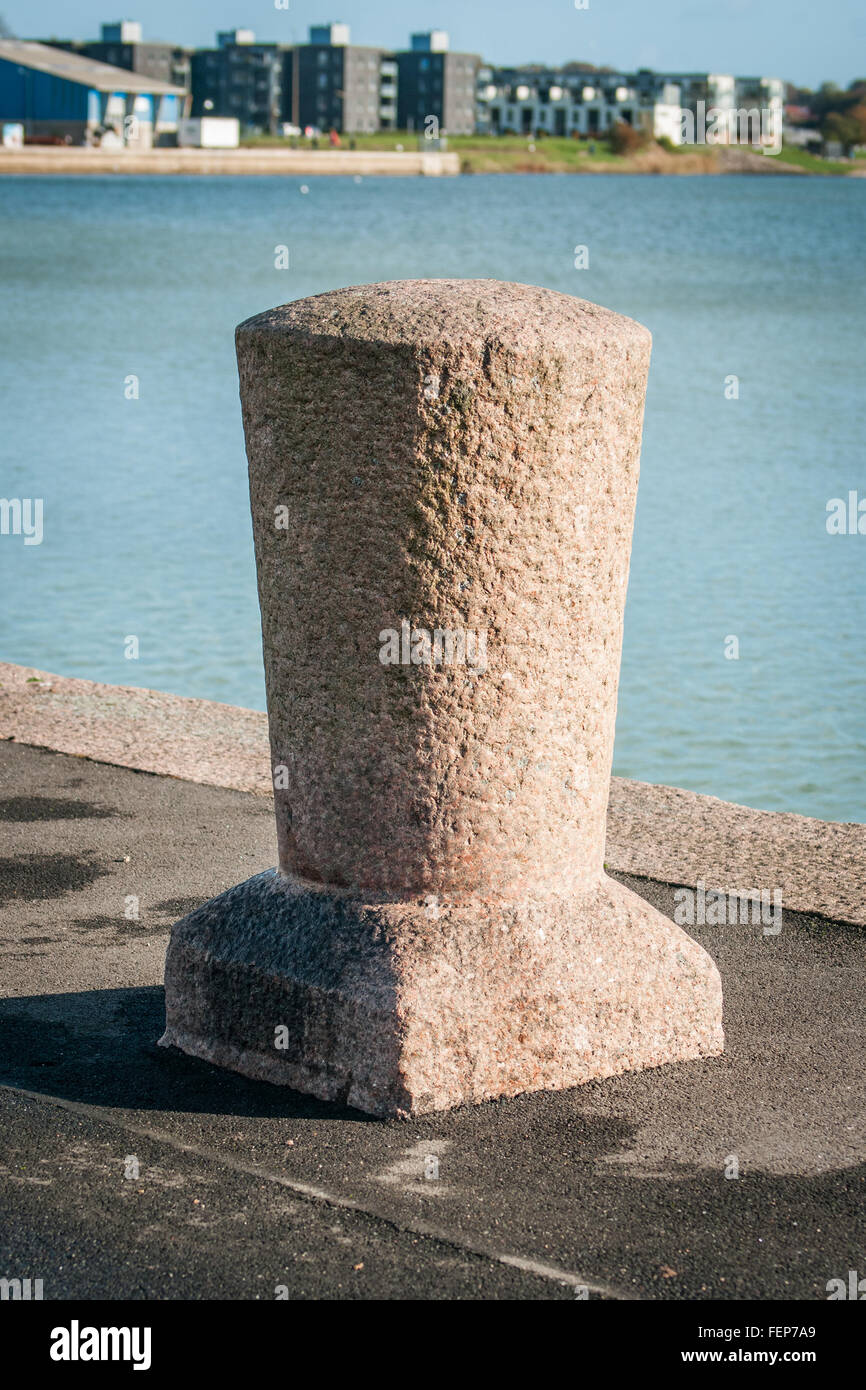 Dock post in stone at the harbor Stock Photo - Alamy