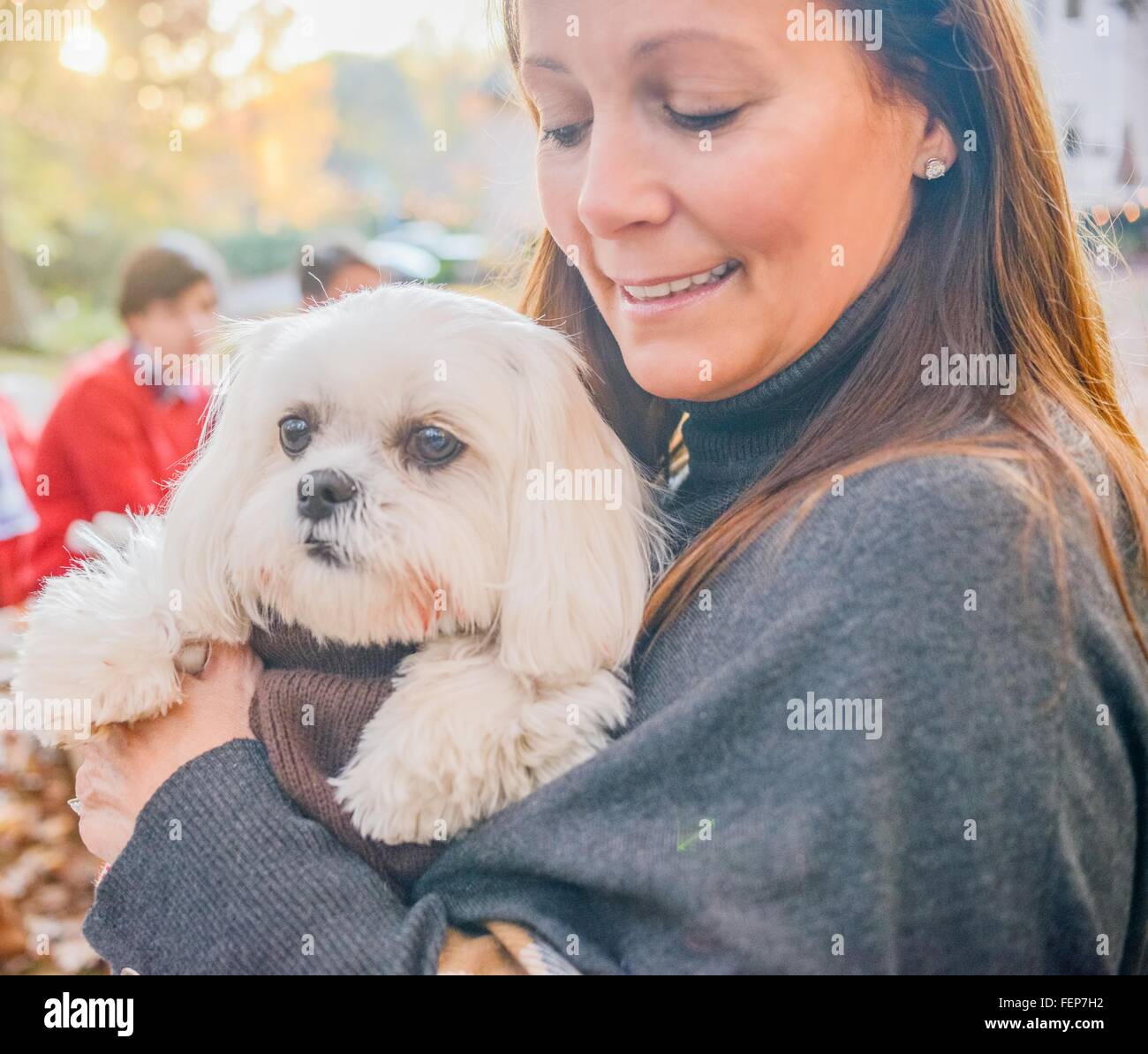Close up portrait of mature woman carrying dog in arms Stock Photo - Alamy