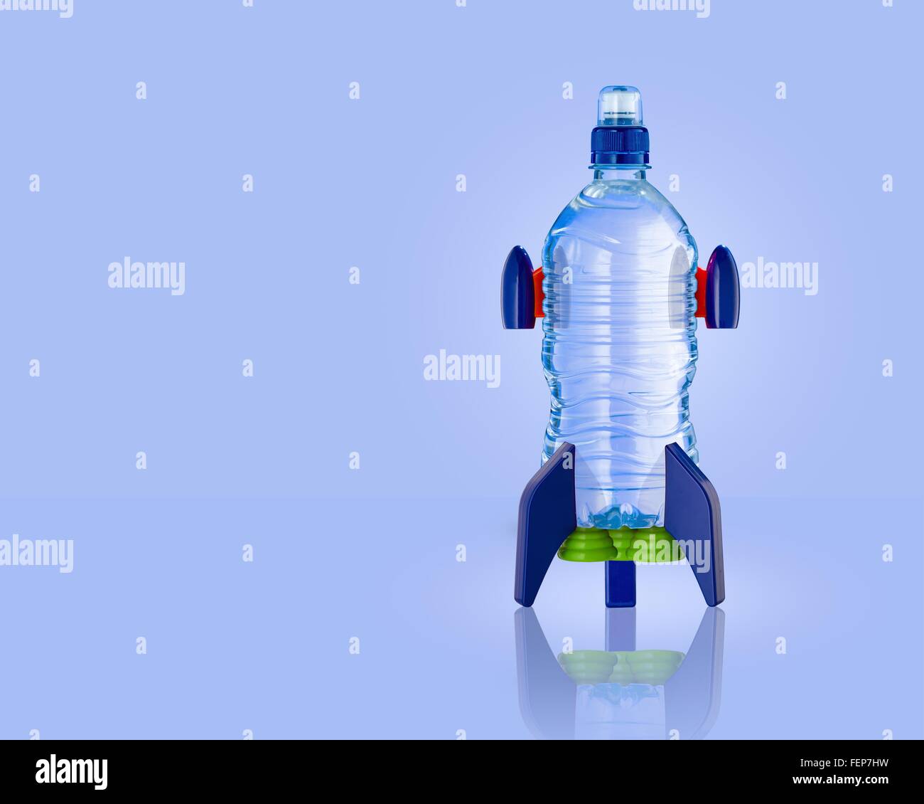 Upright water bottle rocket with blue background Stock Photo - Alamy