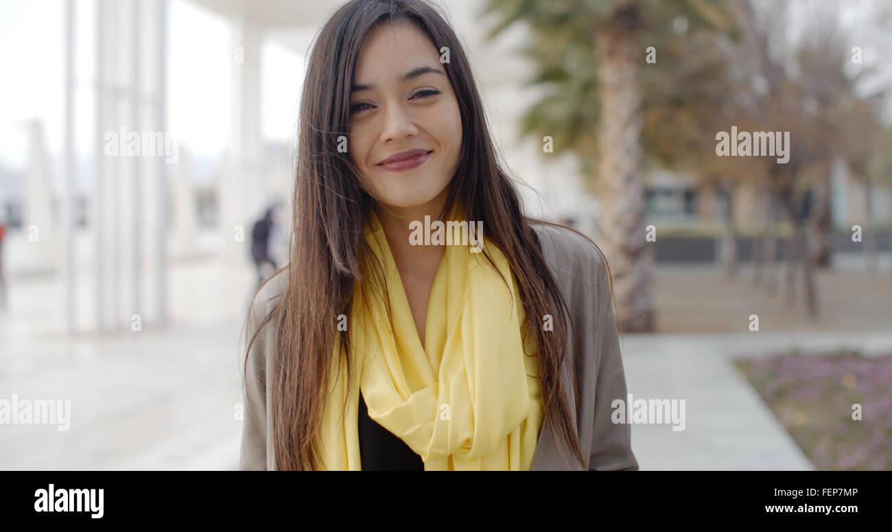 Joyful grinning woman outside in yellow scarf Stock Photo - Alamy