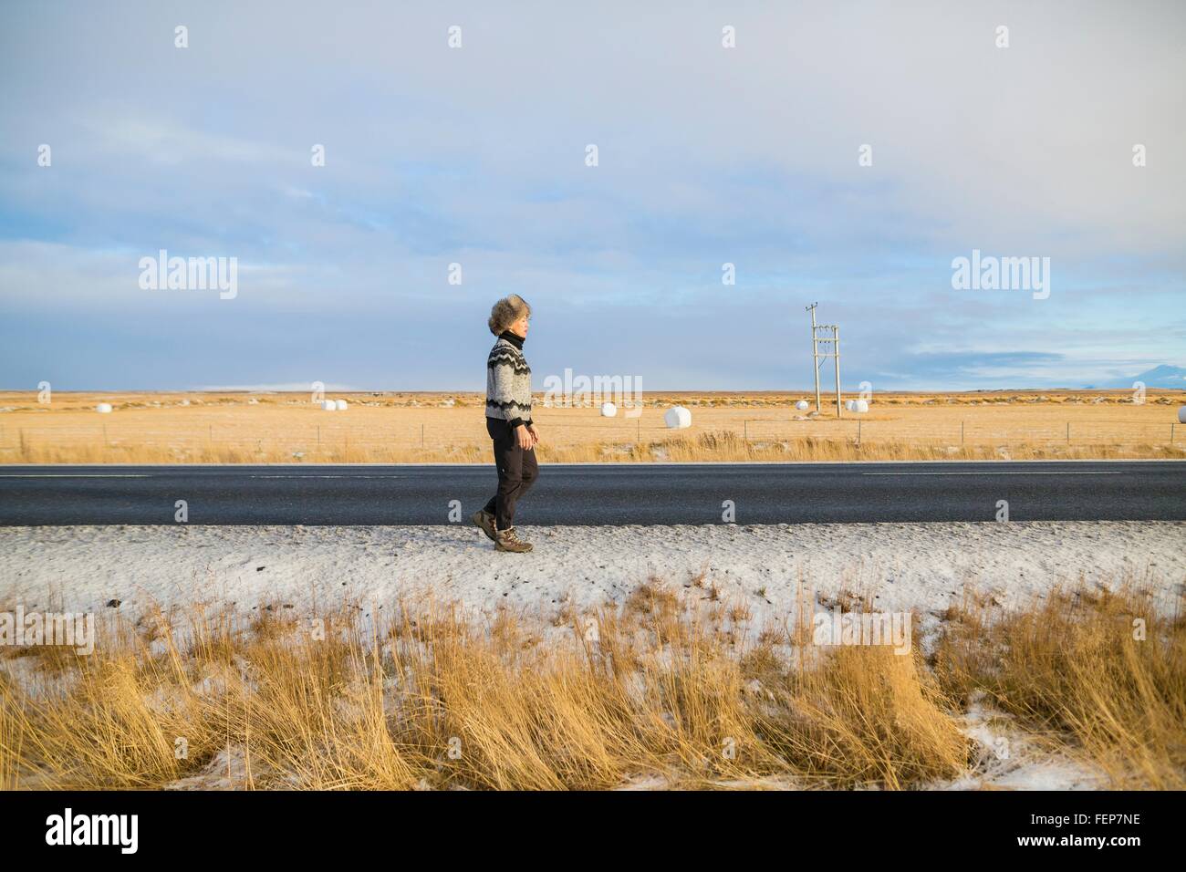 Woman walking along road in hi-res stock photography and images - Alamy