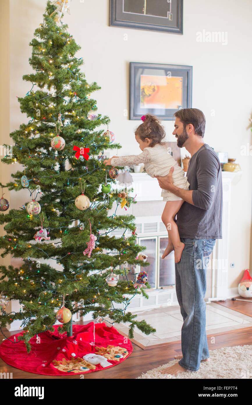 Father and daughter decorating Christmas tree Stock Photo - Alamy