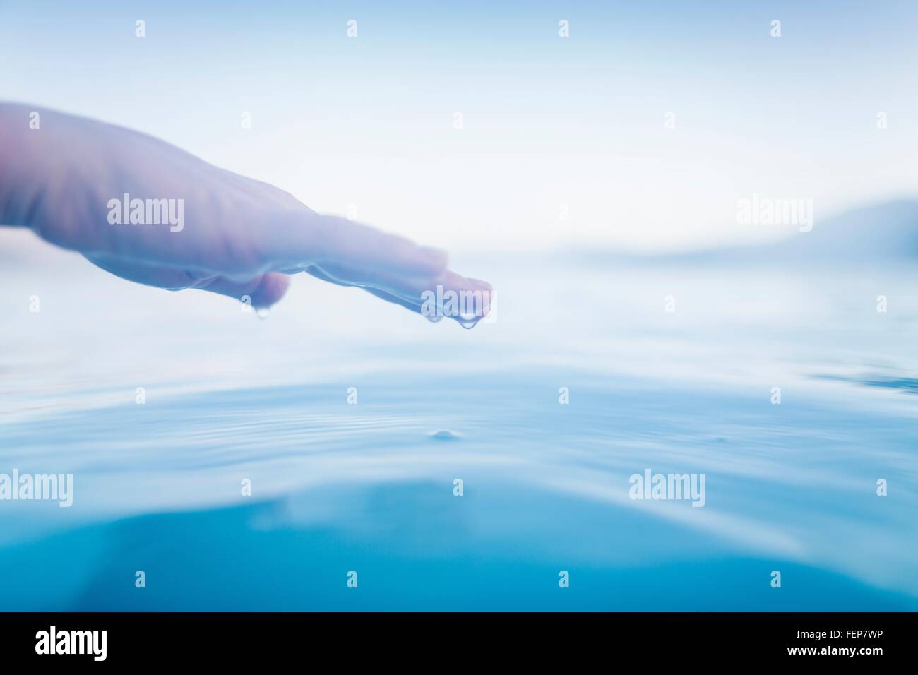 Hand above surface lagoon water Stock Photo - Alamy