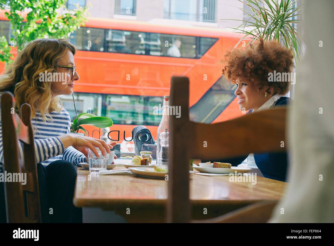 Two women talking in cafe side view hi-res stock photography and images ...