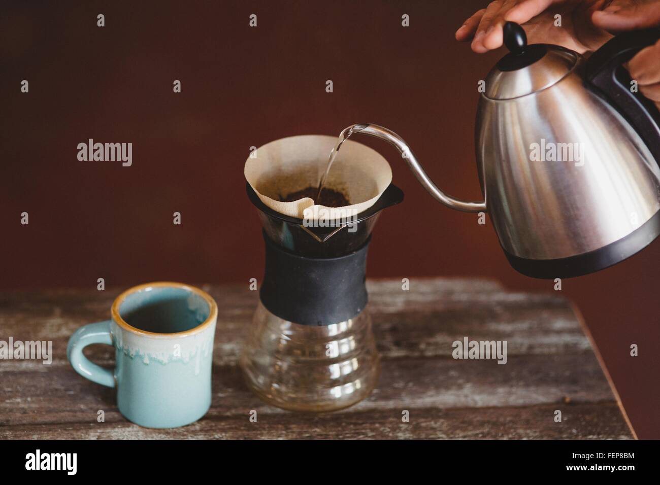 Man pouring water into filter coffee maker Stock Photo - Alamy