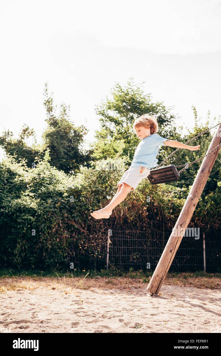 Boy jumping from tree hi-res stock photography and images - Alamy