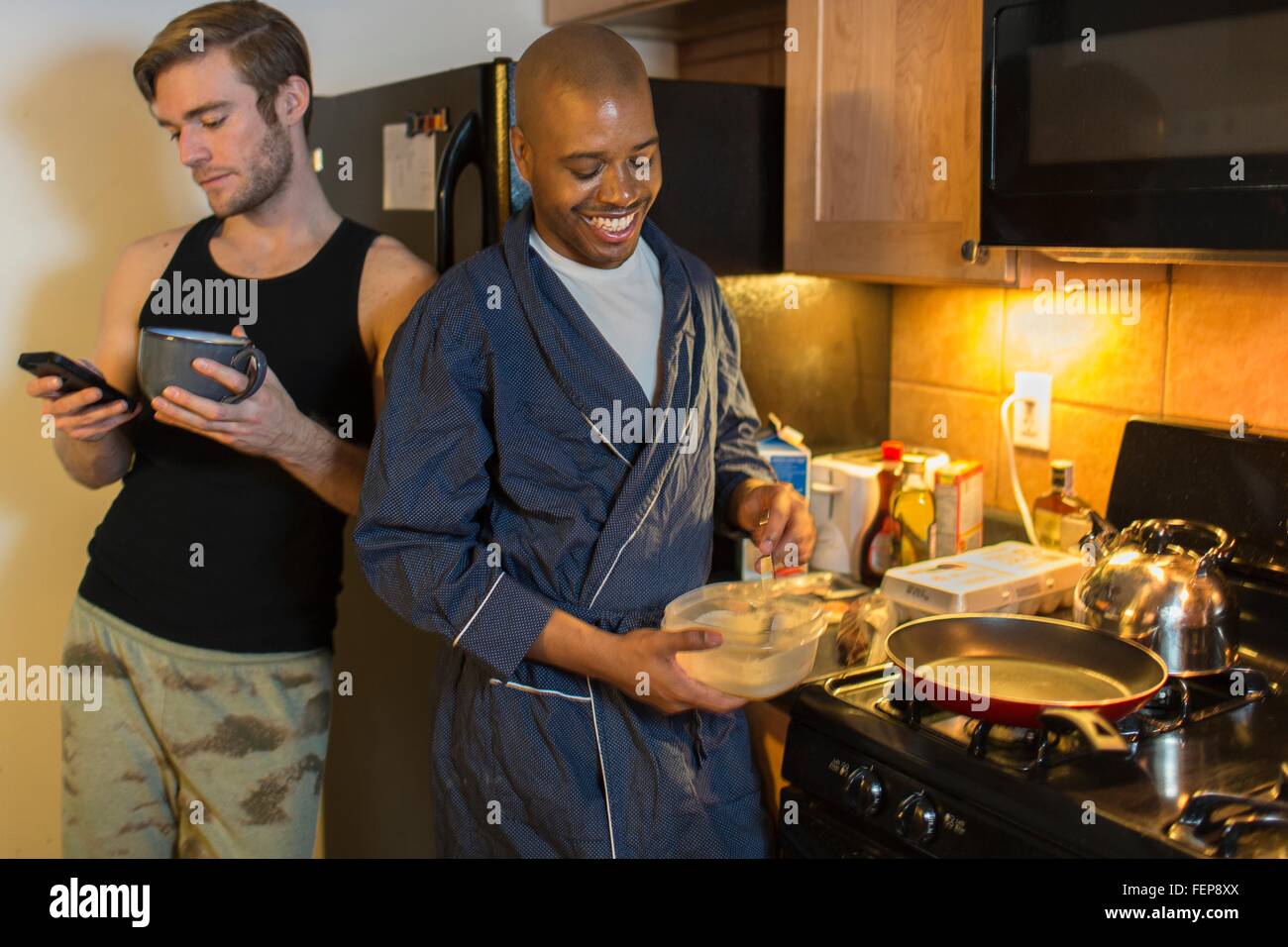 Male couple in kitchen, making breakfast Stock Photo - Alamy