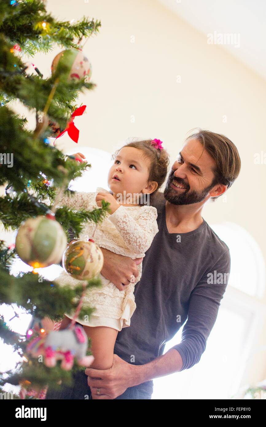 Father and daughter decorating Christmas tree Stock Photo - Alamy