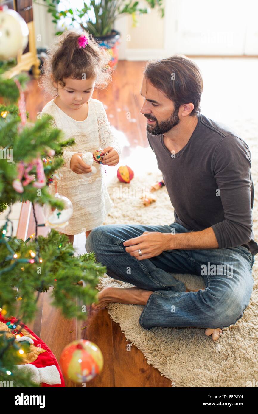 Father and daughter decorating Christmas tree Stock Photo - Alamy