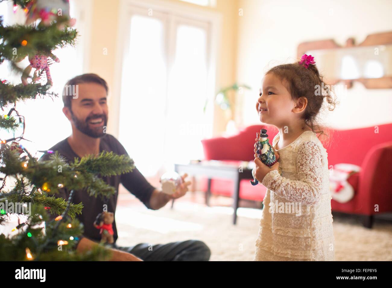 Father and daughter decorating christmas tree Stock Photo - Alamy