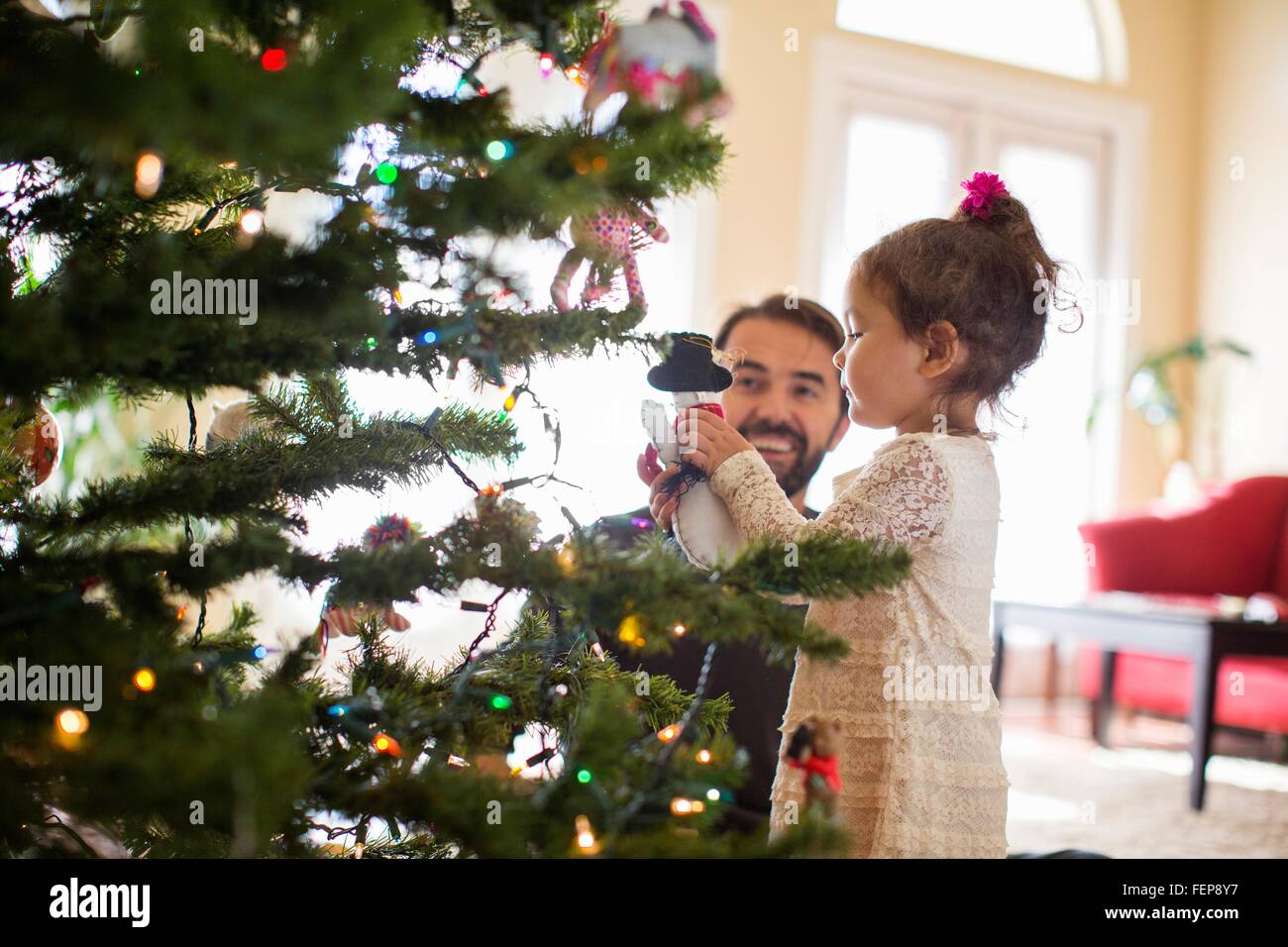 Father and daughter decorating christmas tree Stock Photo - Alamy