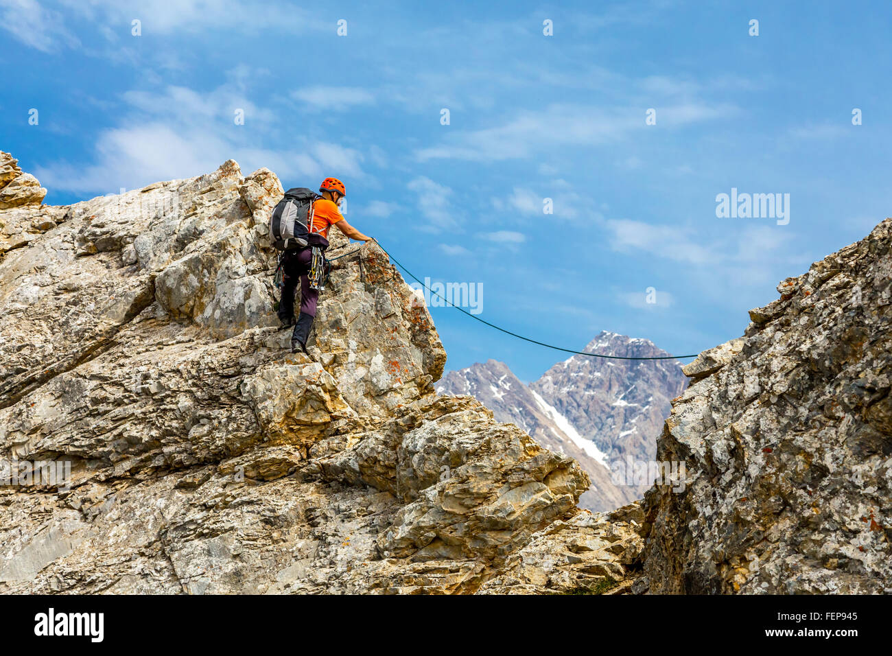 Brave man climbs rocky ridge Stock Photo - Alamy