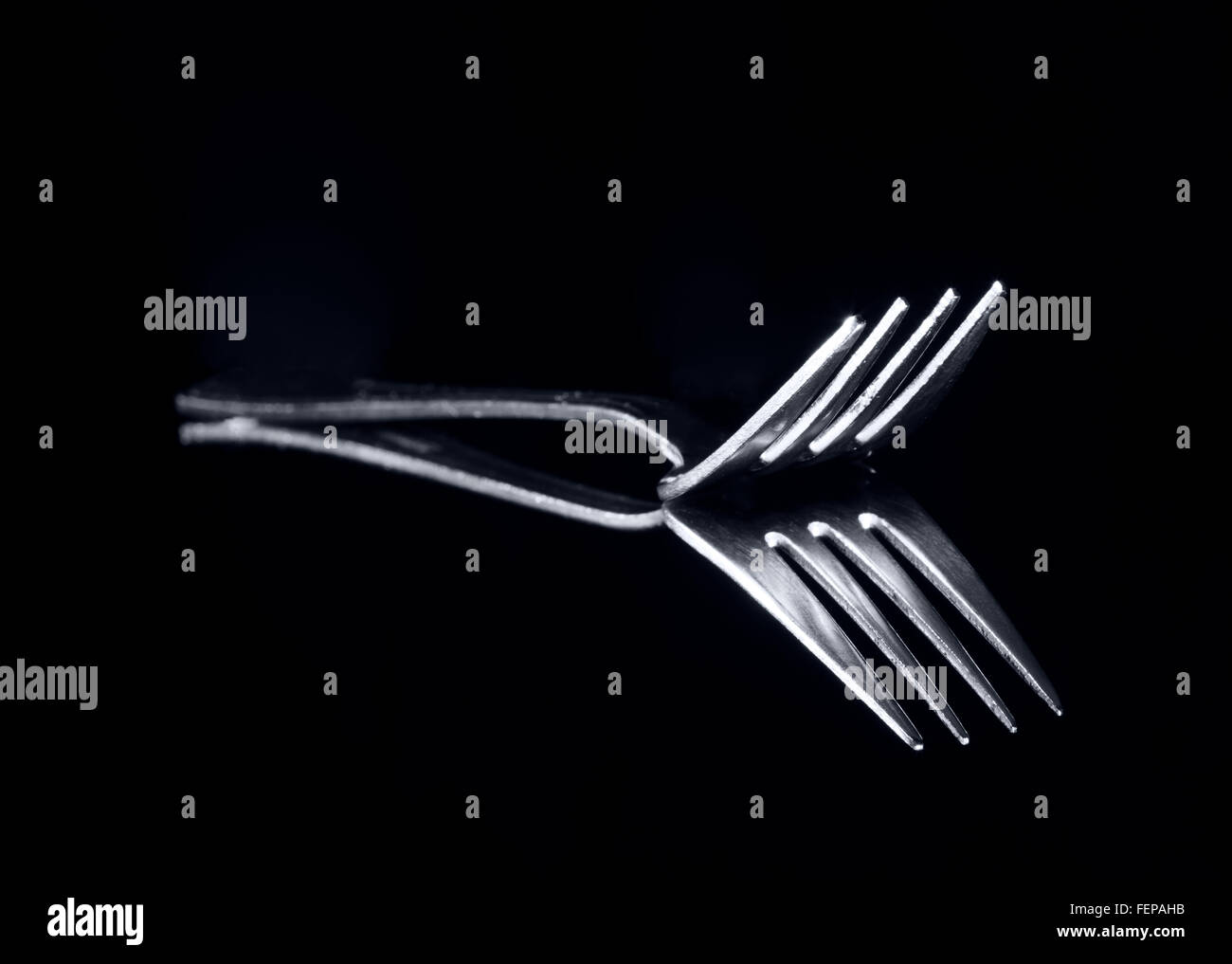 fork reflection on a black background Stock Photo - Alamy