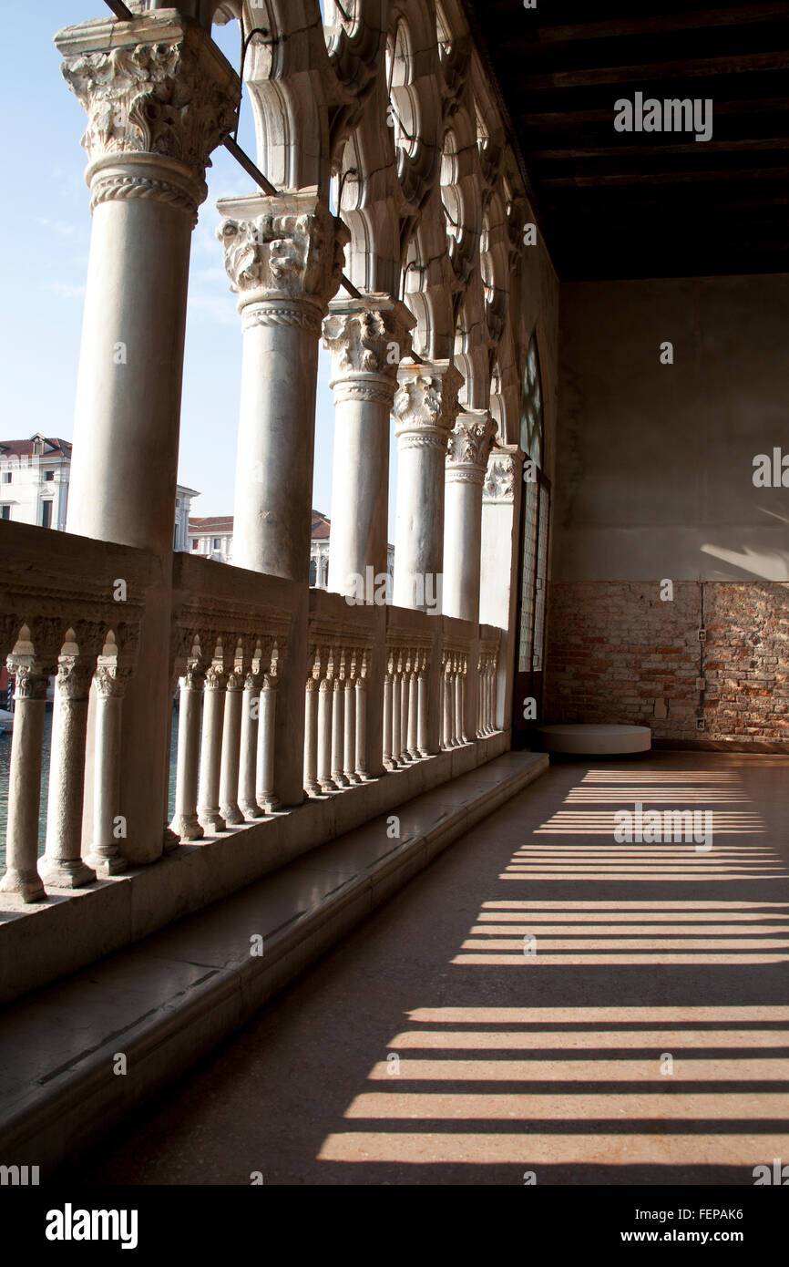 Balcony columns and arches with shadows overlooking the Grand Canal Ca ...