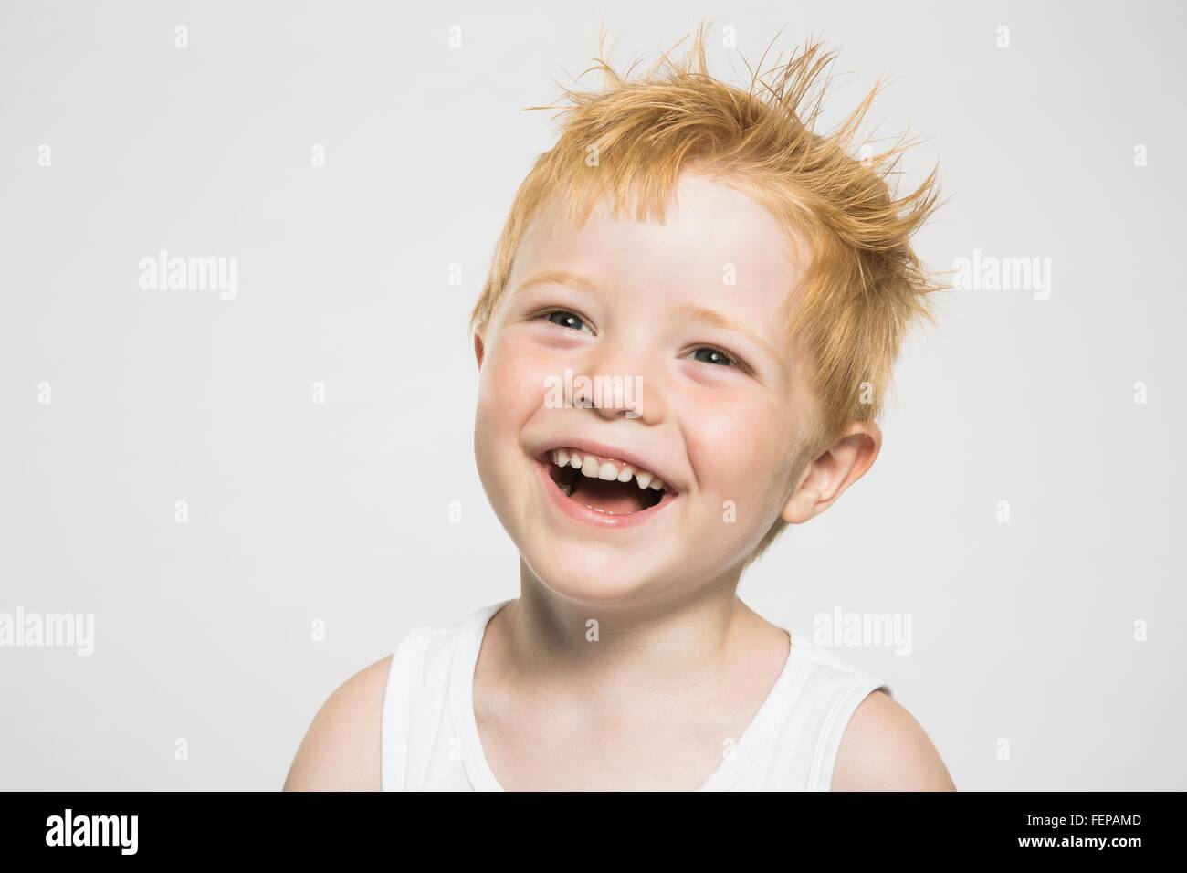 Studio portrait of cute boy with ginger hair Stock Photo - Alamy