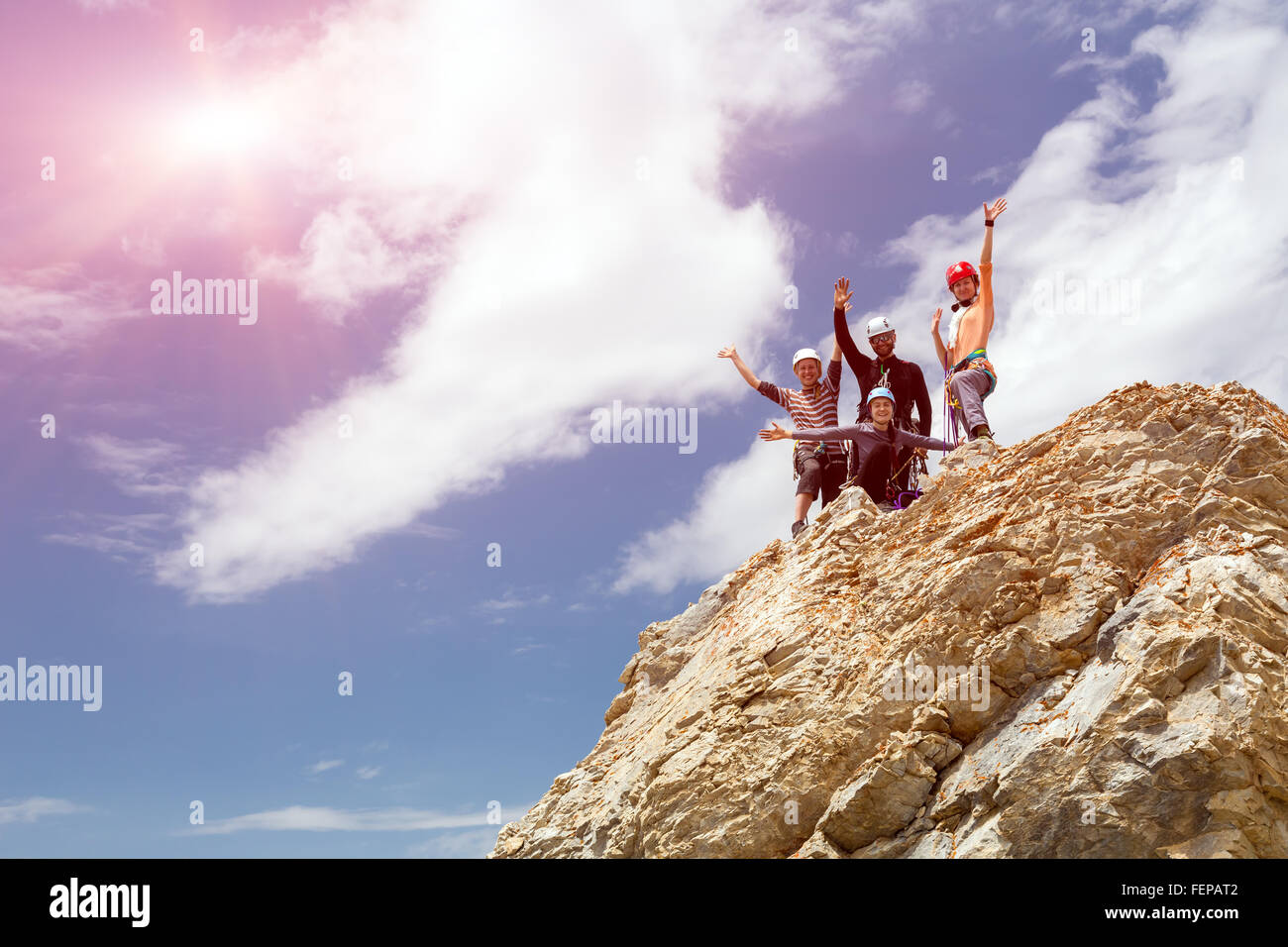 Team of climbers on summit Stock Photo - Alamy