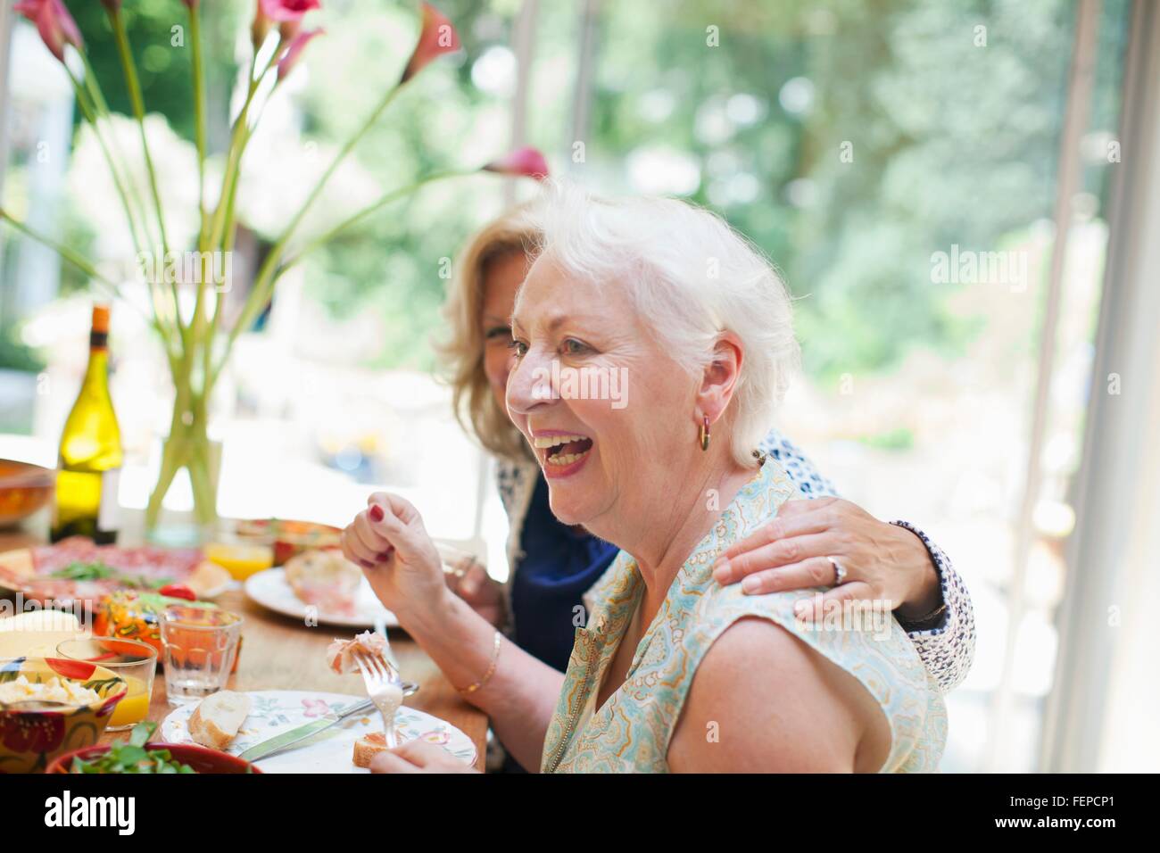 Two women having lunch together at home Stock Photo - Alamy