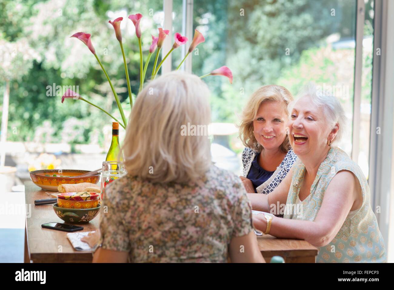 Three women having lunch together at home Stock Photo - Alamy