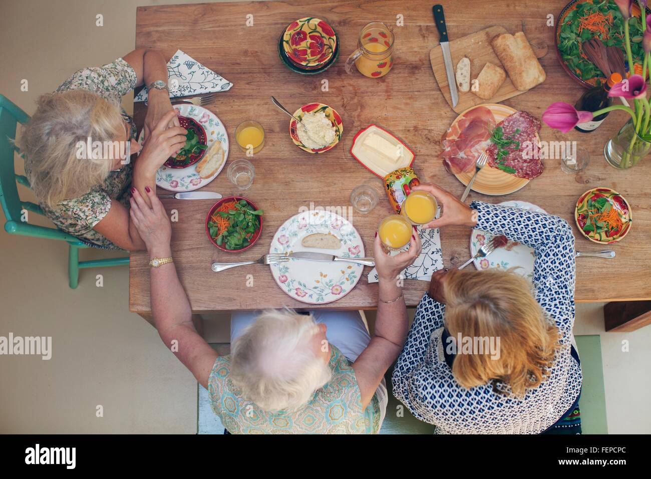 Three women having lunch together at home, overhead view Stock Photo ...