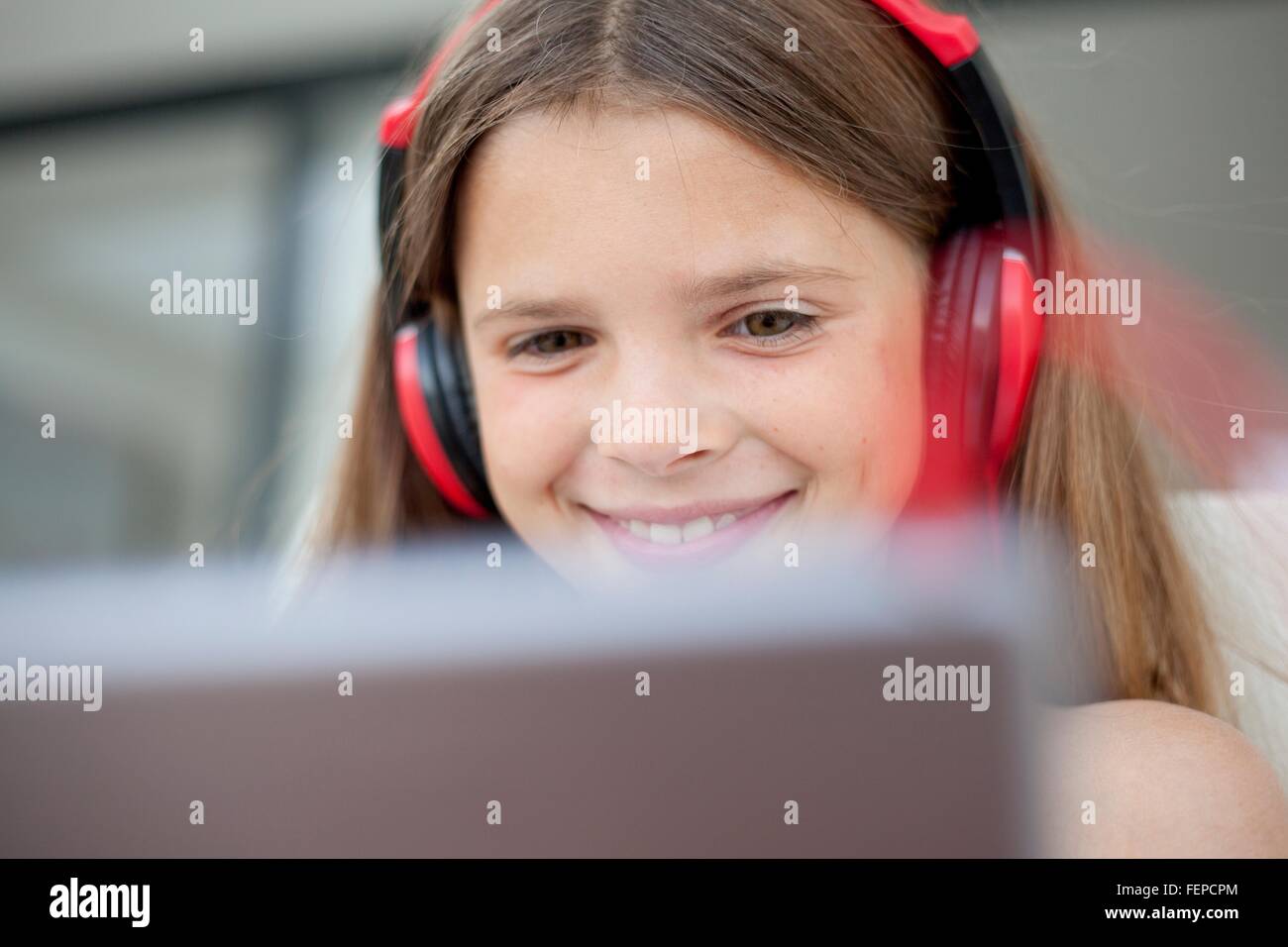 Girl wearing headphones using computer Stock Photo - Alamy