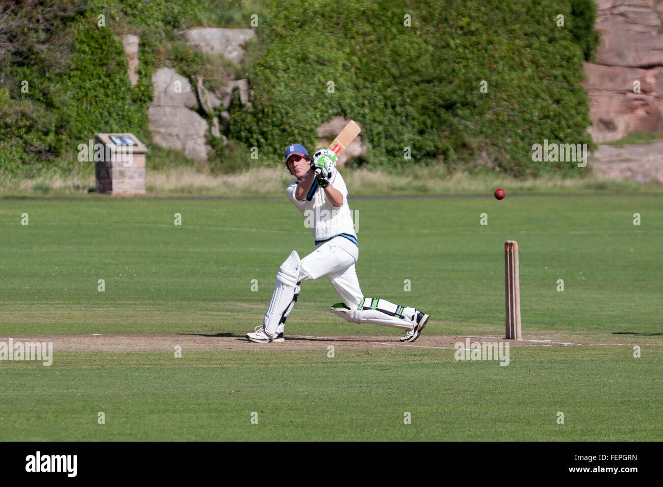Playing cricket on the green at Bamburgh Stock Photo - Alamy
