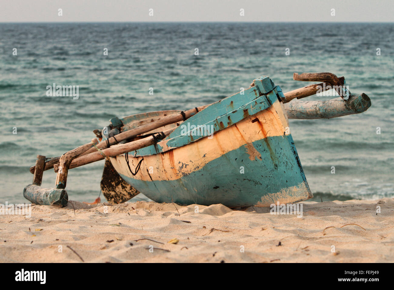 An indigenous fishing boat or canoe or type of dhow is lying on the ...