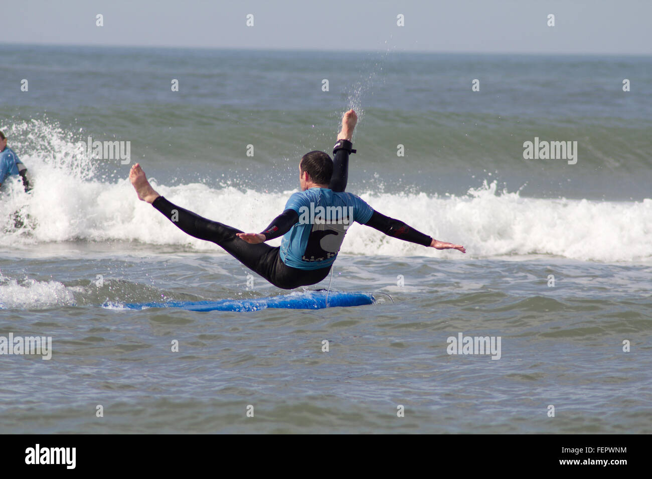 Man falling off surfboard Stock Photo - Alamy