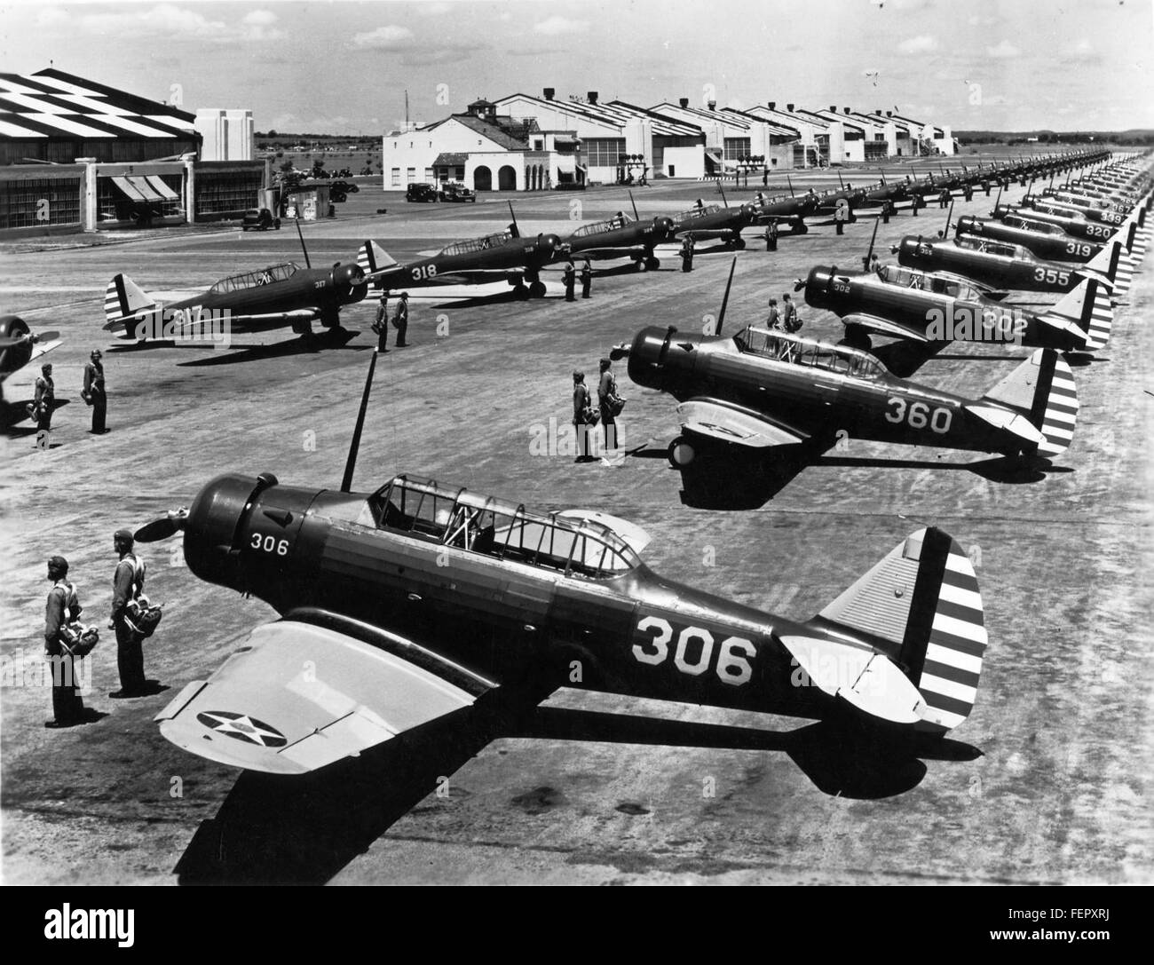 This photo features a North American BT-9 on the flight line at ...