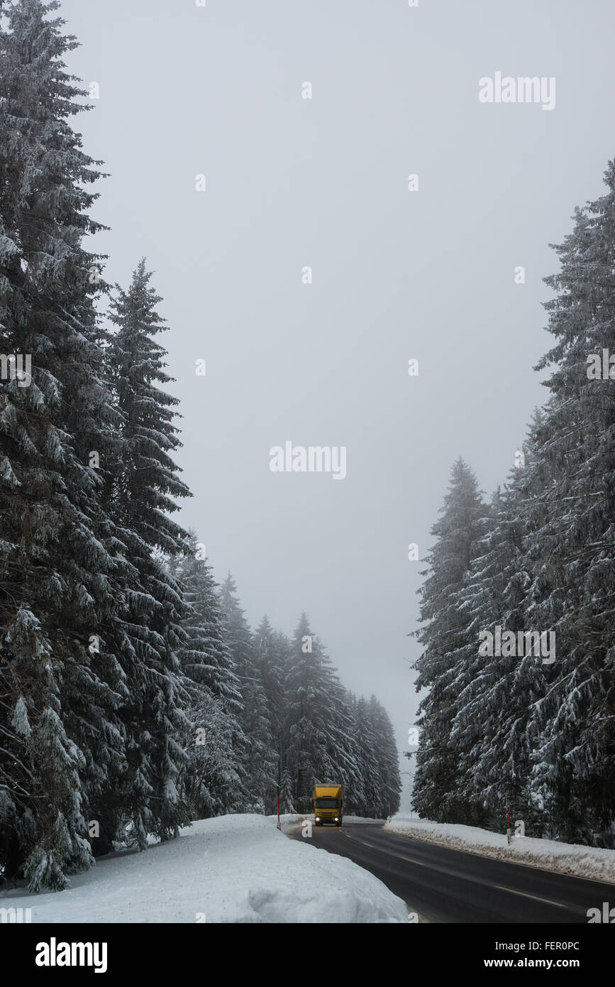 Lorry driving on winter road Stock Photo - Alamy