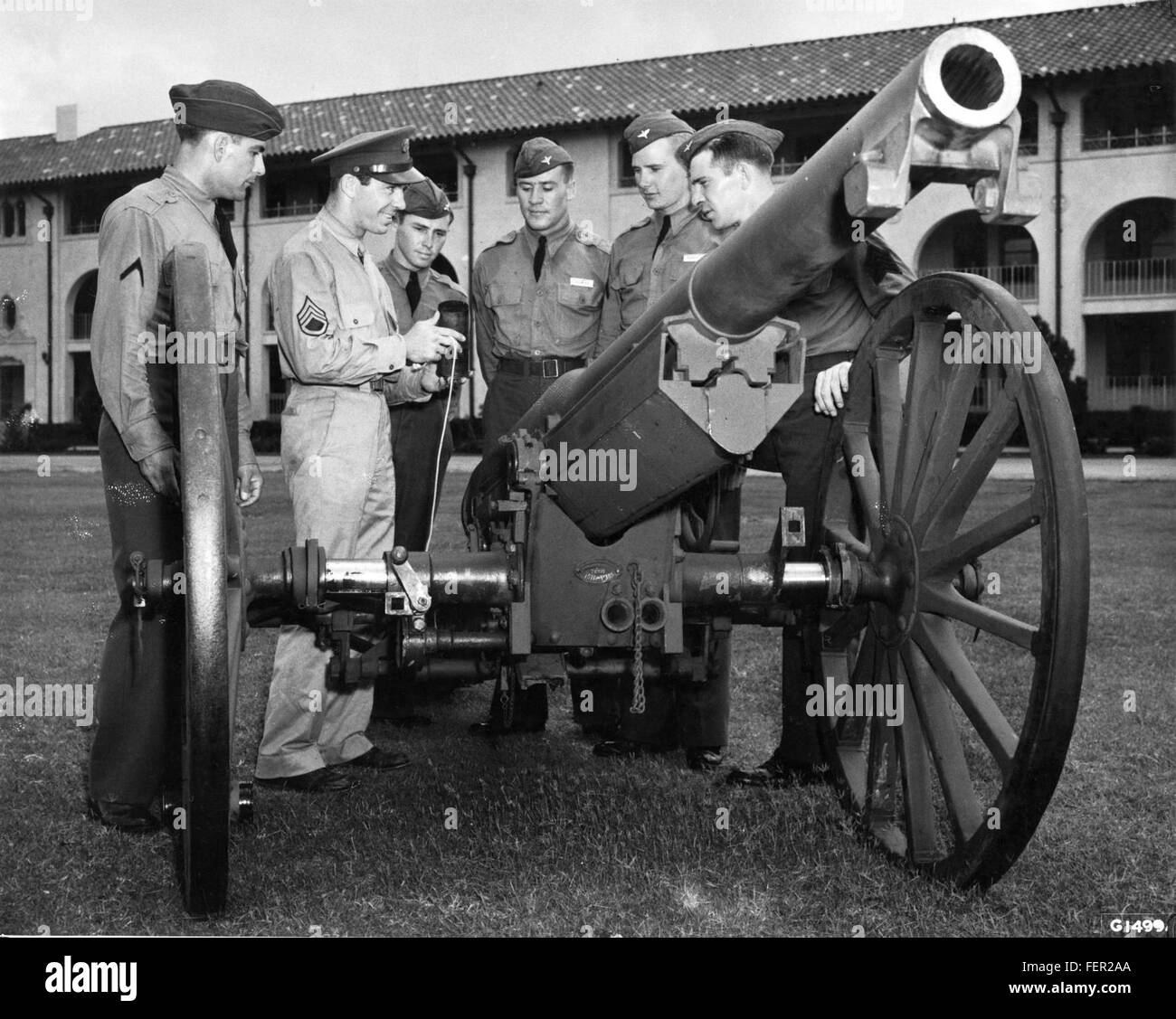 Cadets at Randolph Field are seen inspecting and saluting a gun as part ...