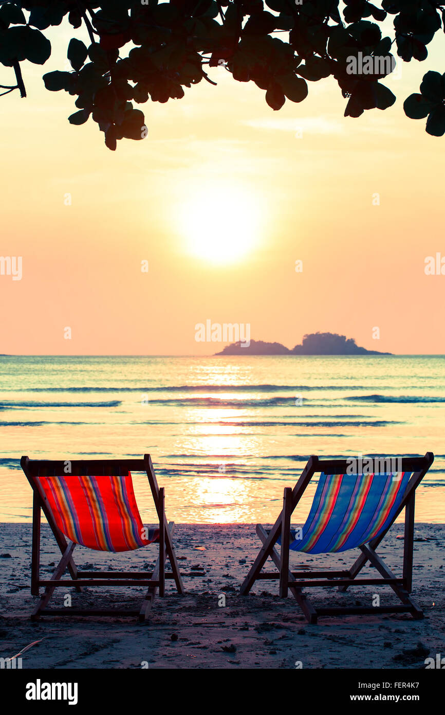 Pair of lounge chairs on sunset at beach Stock Photo - Alamy