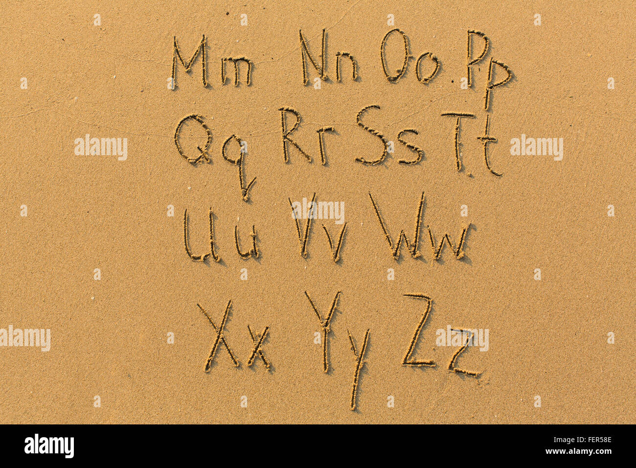 Alphabet writing on sand letter hi-res stock photography and images - Alamy