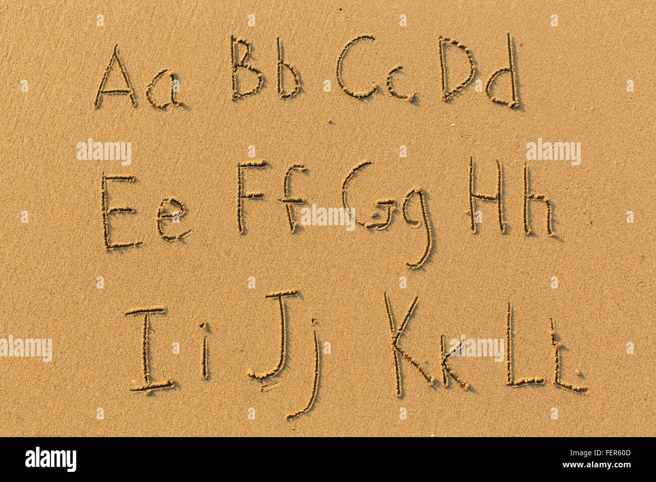 Alphabet writing on sand letter hi-res stock photography and images - Alamy