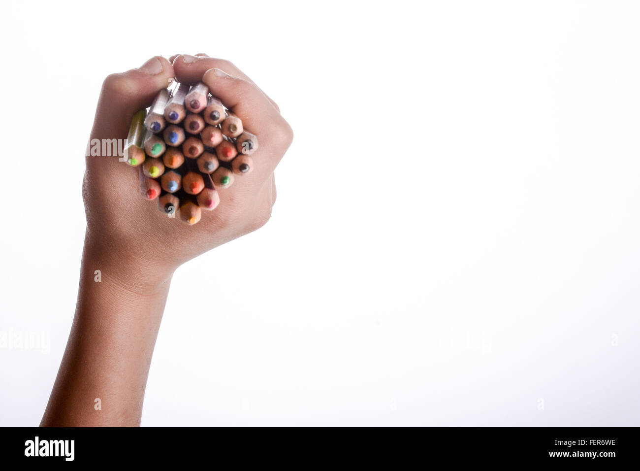 child holding colour pencils in hand on white background Stock Photo ...