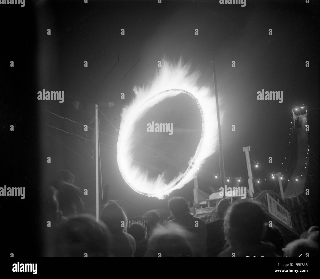 A time-lapse exposure captures a skier jumping through a hoop in ...