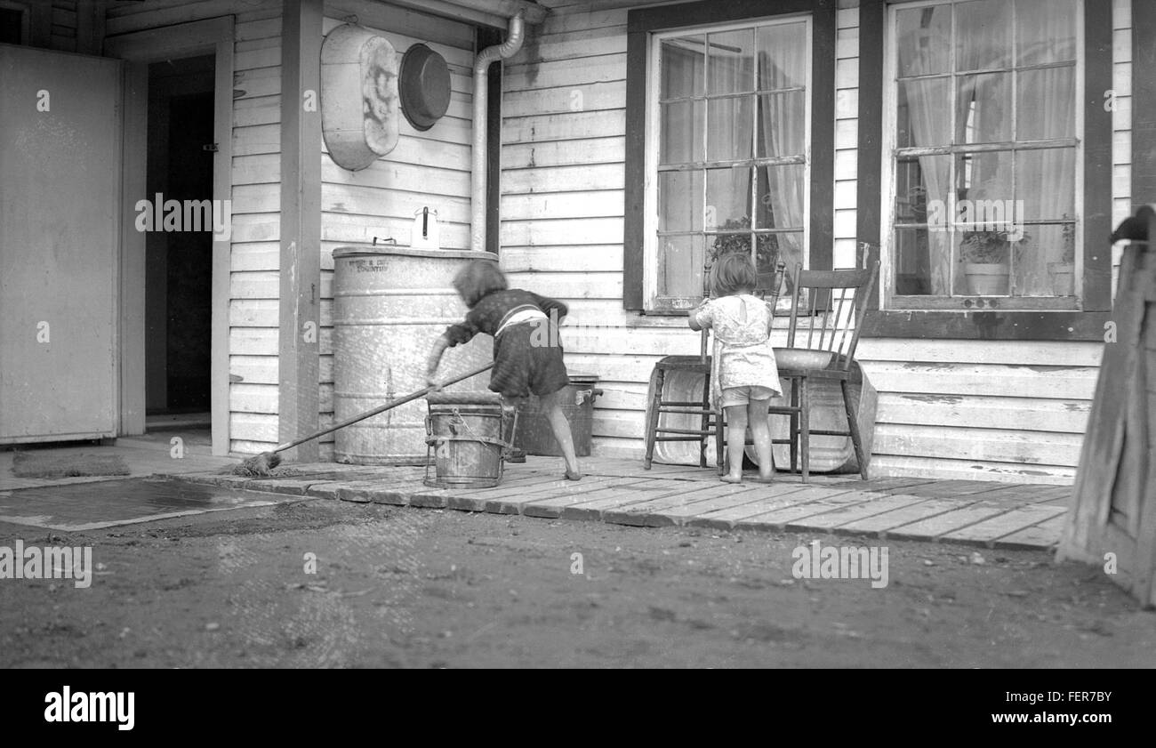 The photo shows the Lee girls cleaning the porch, a domestic scene from ...
