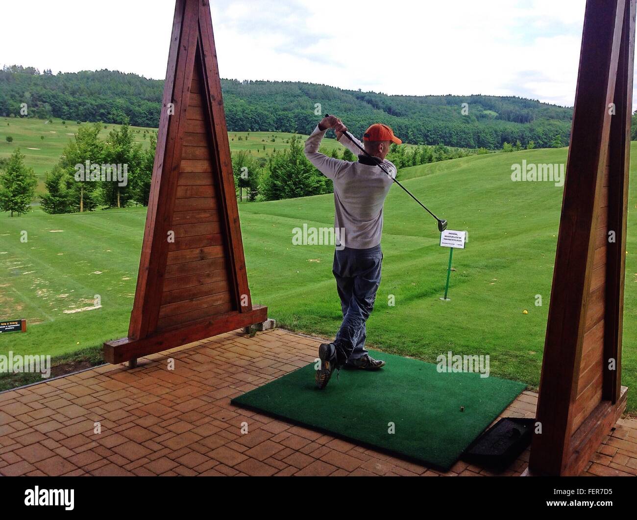 Rear View Of Man Swinging Golf Club On Ground Stock Photo - Alamy